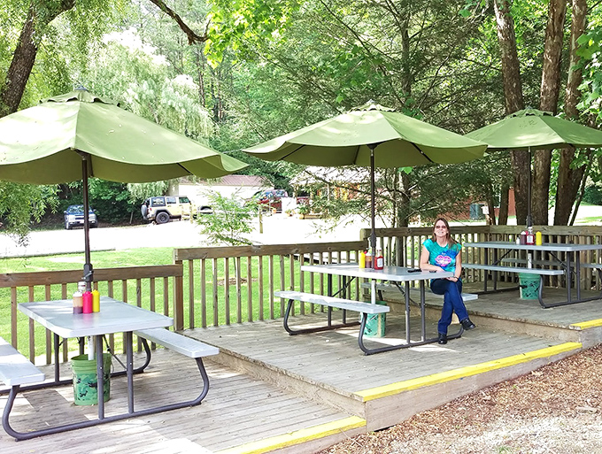 Outdoor seating under green umbrellas offers a peaceful retreat. Nature provides the scenery while Jim's provides the reason to linger.