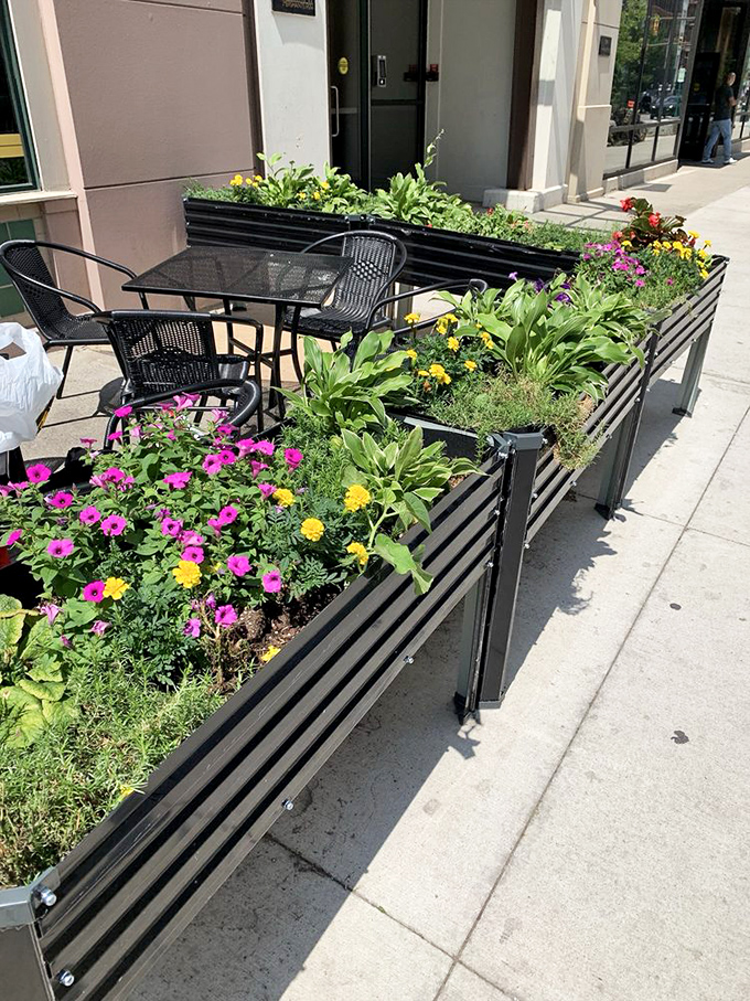 The sidewalk garden creates an urban oasis, where breakfast and blooms coexist in downtown harmony.