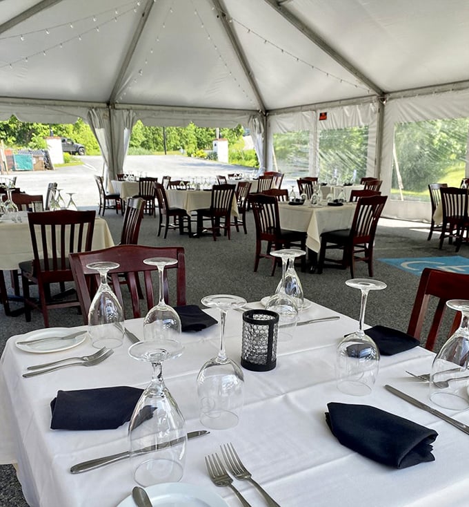 Outdoor dining under canvas&mdash;where fresh air meets fresh seafood. White tablecloths and inverted glasses await the next lucky diners.