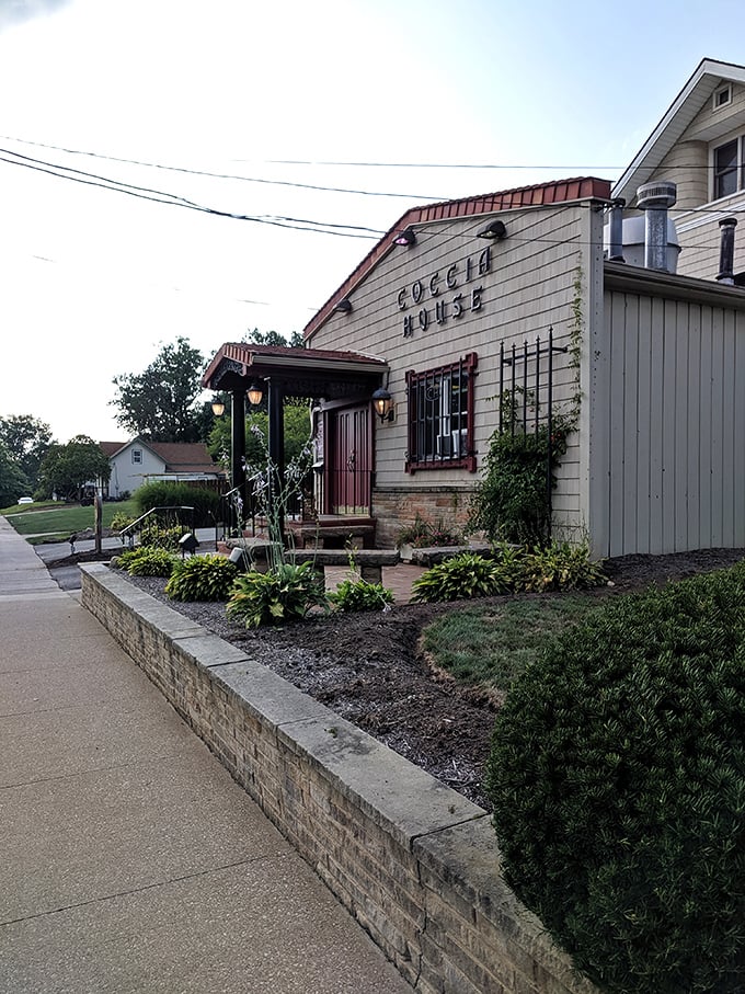 The side view reveals charming landscaping and thoughtful details that make this converted house feel like the neighborhood living room.