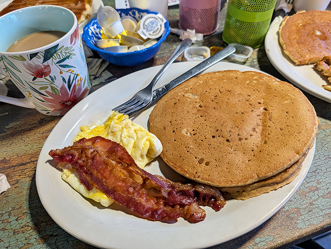 Pancakes so perfectly golden they deserve their own Florida sunrise postcard, with bacon playing a delicious supporting role.