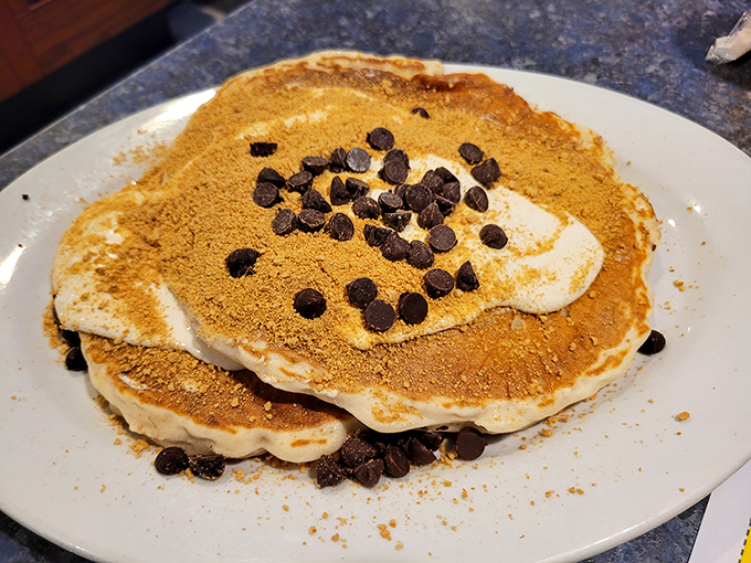 These aren't just pancakes—they're edible pillows dusted with cinnamon and chocolate chips, ready to soak up maple syrup like they've been waiting their whole lives for this moment.