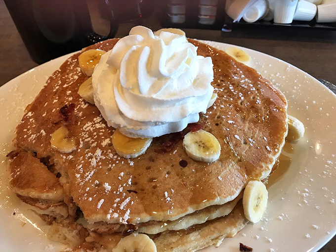 Pancakes stacked higher than my unread emails, crowned with whipped cream and bananas. Monday problems require pancake solutions.