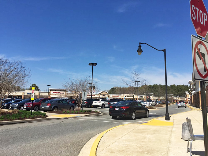The parking lot at midday resembles a strategic game of asphalt chess. Veterans know to arrive early or embrace the walk.