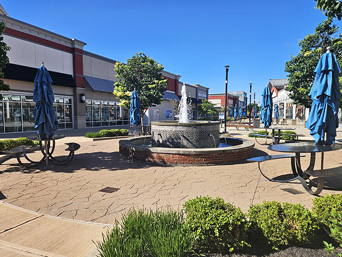 This fountain courtyard isn't just pretty&mdash;it's a tactical rest stop where shopping strategies are recalibrated and second winds are caught. Those blue umbrellas offer shade for the serious planners.