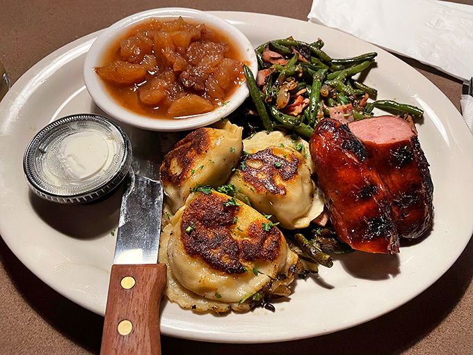 A plate that screams "Ohio heritage" – golden pierogies, smoky sausage, and green beans that would make your grandmother nod in approval.