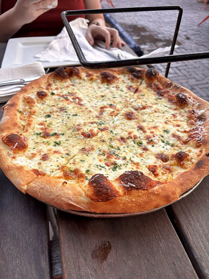 The white pie isn't playing second fiddle to its red sauce siblings&mdash;it's conducting its own symphony of garlic, herbs, and cheese.