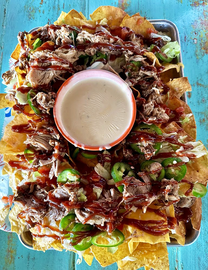 Nachos that refuse to be ordinary&mdash;crispy chips loaded with pulled pork, jalape&ntilde;os, and enough toppings to require a strategic eating plan.