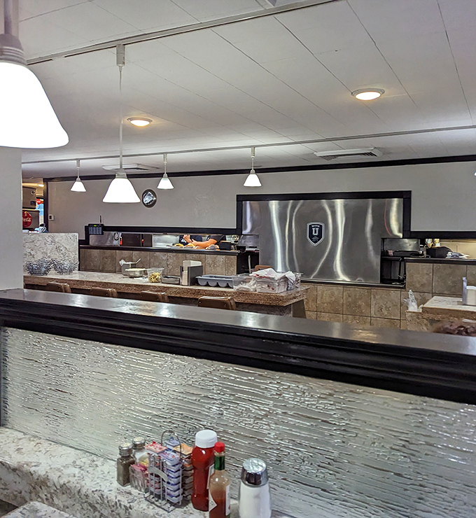 Behind the counter, culinary magic happens with practiced efficiency &ndash; breakfast alchemy that turns simple ingredients into gold.