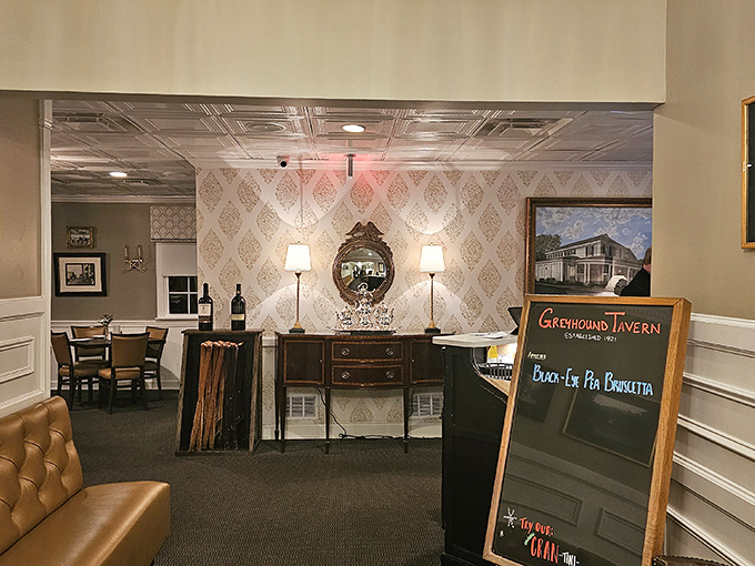 Elegant entryway with vintage-inspired wallpaper and warm lighting that whispers, "The calories don't count if the ambiance is this good."