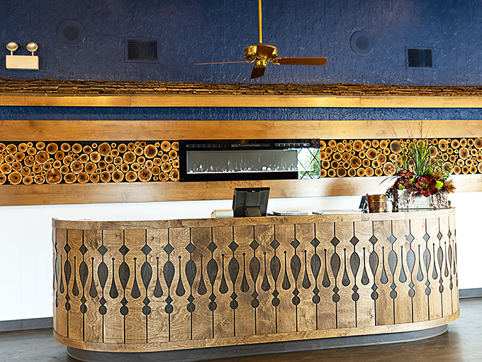 A reception desk that looks like it belongs in a rustic mountain lodge. The wood detailing practically tells stories of its own.