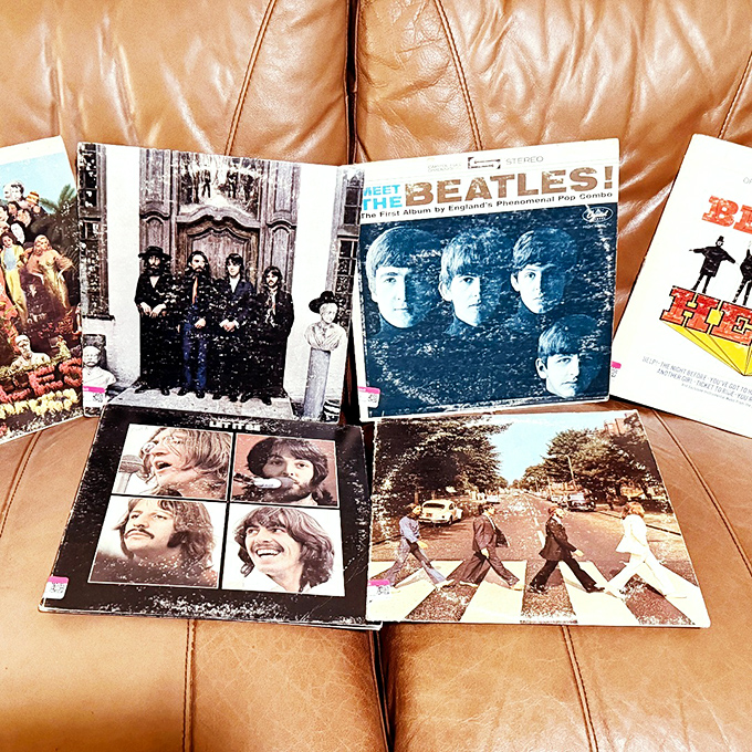 Beatles albums lounging on leather—the ultimate thrift store jackpot. Abbey Road never looked so good as when discovered between forgotten Christmas albums and classical records.