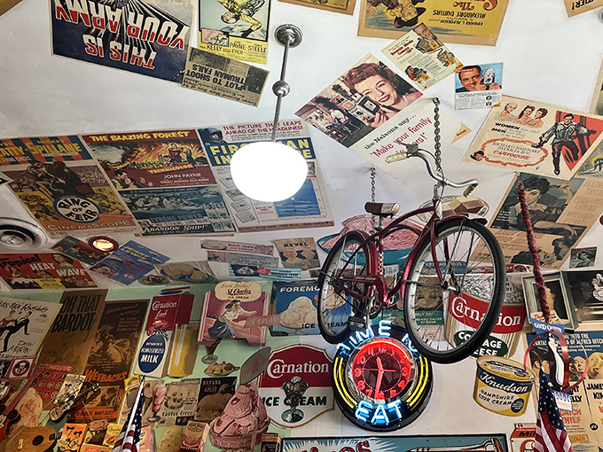 Even the ceiling joins the party, covered in enough memorabilia to keep archaeologists busy for decades.