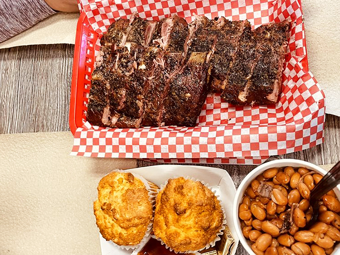 Ribs, cornbread, and beans - the holy trinity of barbecue sides assembled on one glorious plate.