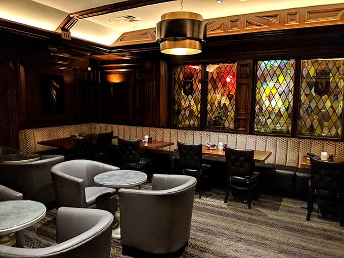 Leather seating and stained glass windows create intimate corners for hushed conversations and lingering nightcaps.
