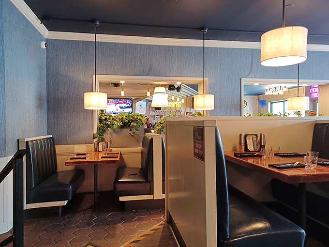 Cozy booth seating bathed in soft lighting creates intimate dining spaces where conversations and exceptional meals can both take center stage.