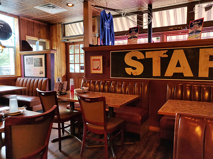 Comfortable booths line the walls where countless pizza-fueled conversations have unfolded beneath the watchful gaze of Chicago memorabilia.
