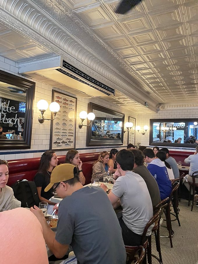 Red booths and pressed-tin ceilings creating that perfect blend of classic charm and bustling energy that makes every meal memorable somehow.