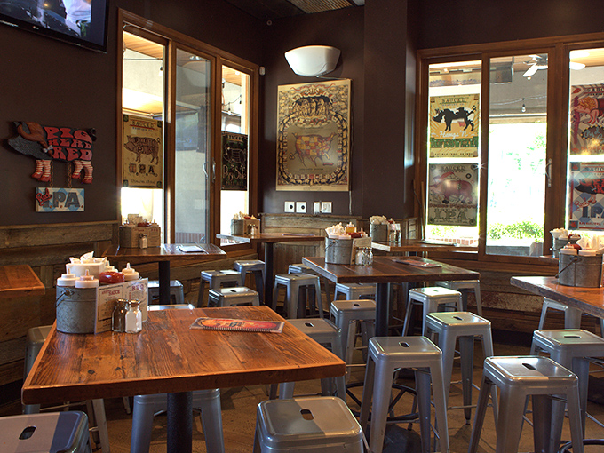 Rustic wooden tables paired with industrial stools &ndash; where barbecue philosophies are debated and sauce-stained napkins tell tales of delicious defeat.