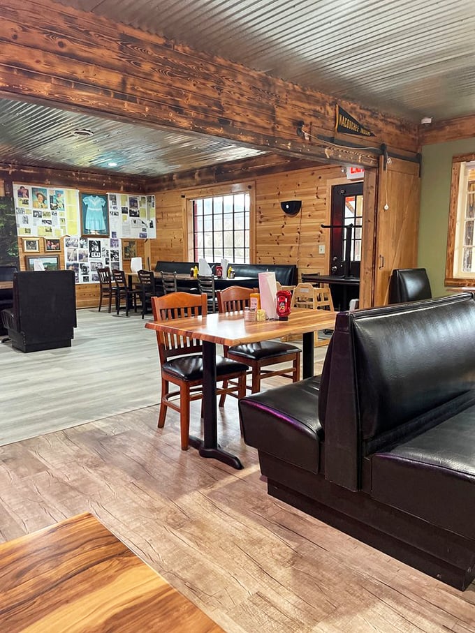 Exposed beams and mixed seating options create that casual mountain lodge vibe where strangers become biscuit-eating buddies over shared meals.
