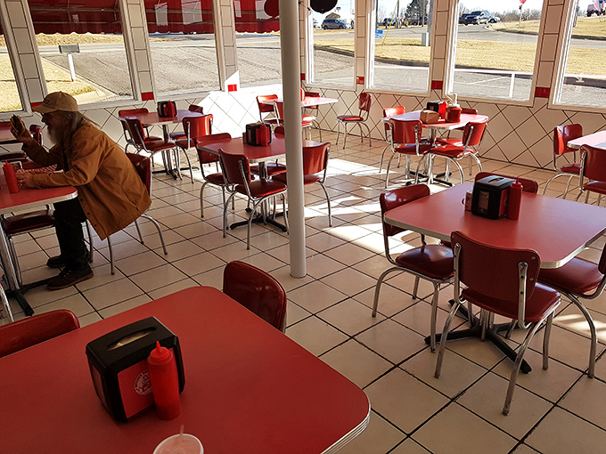 Sunlight streams through windows onto empty tables, a fleeting calm before the inevitable burger-seeking crowds descend.