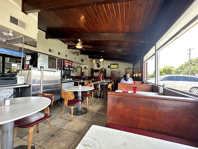 Red vinyl booths and wooden chairs create that classic diner comfort we all secretly crave.