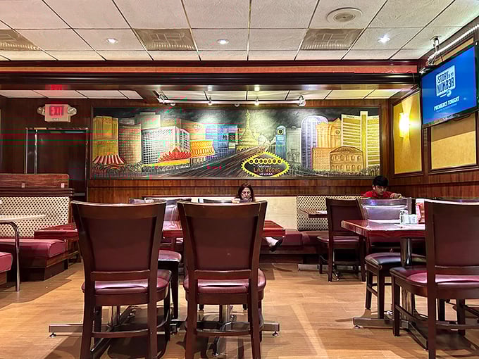 Red booths, wood accents, and that Vegas mural create the perfect backdrop for conversations that stretch from coffee to dessert and beyond.