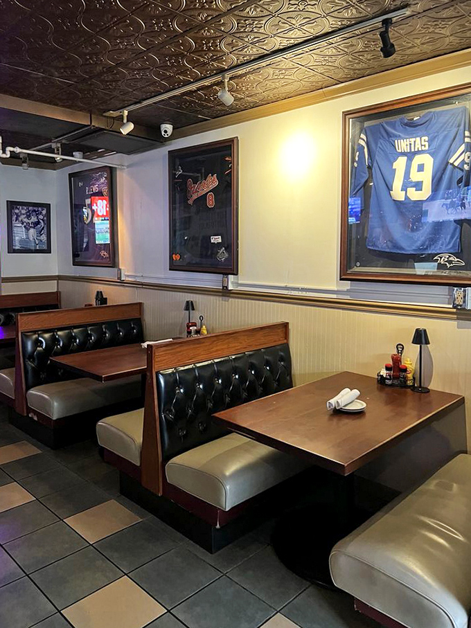 Classic booth seating in the sports bar area, complete with Baltimore sports memorabilia. Johnny Unitas watches over your meal from his framed perch.