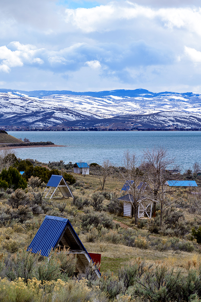 Winter retreats with A-frame charm dot the landscape, promising cozy shelter after days spent exploring snow-dusted shores.