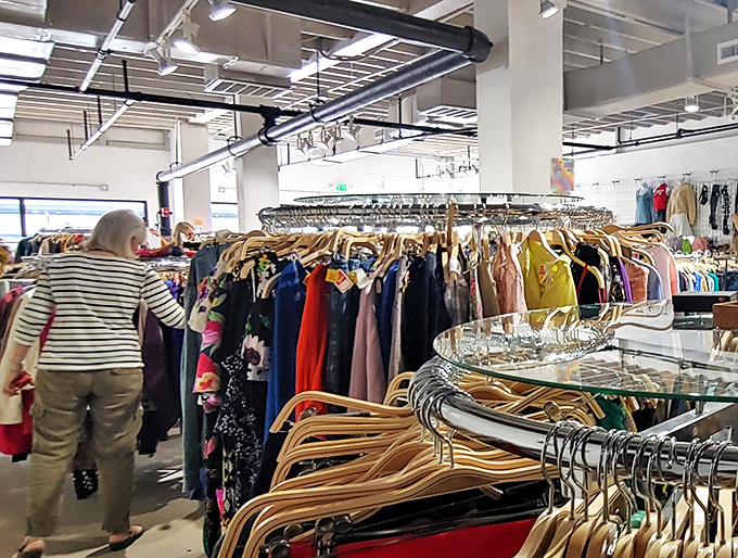 Fellow shoppers navigate the fashion forest with the focused determination of treasure hunters who know the next great find could be just a rack away.