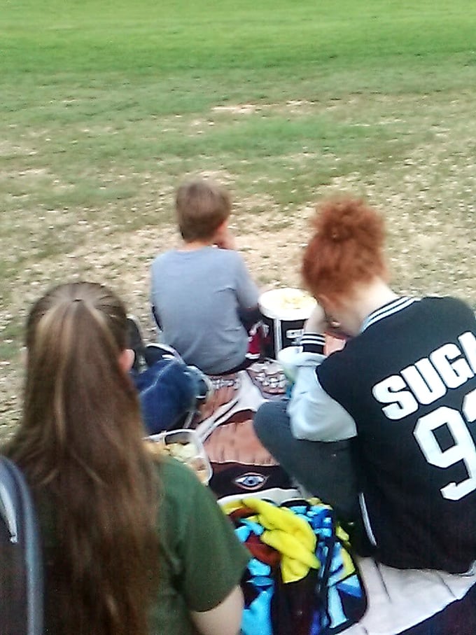 Families gather with popcorn and blankets, creating memories that will outlast the evening's film.