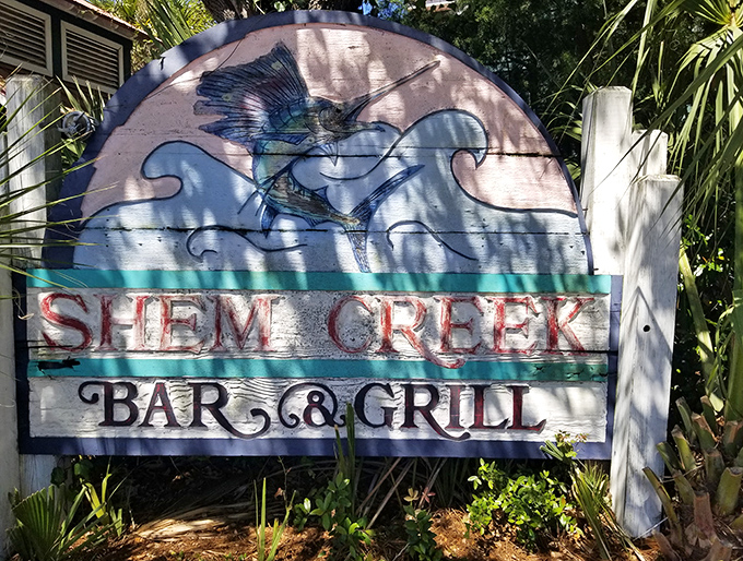 A weathered sign that's seen countless sunsets and seafood feasts &ndash; like a maritime postcard come to life.