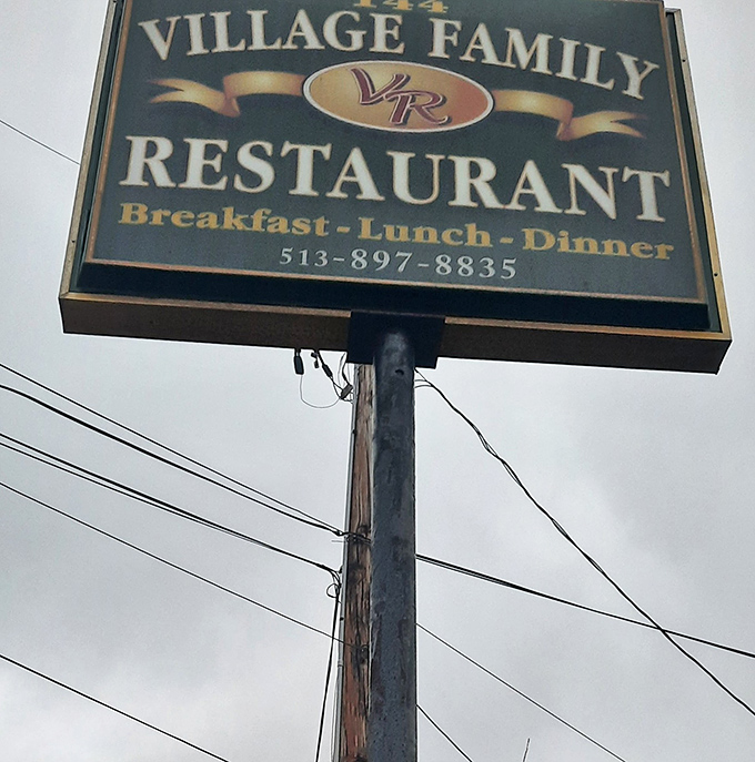 The roadside sign announces "Breakfast-Lunch-Dinner" like a promise that covers all your hunger-based emergencies.