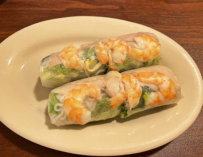 Fresh spring rolls wrapped in translucent rice paper showcase plump shrimp and herbs, light and refreshing like summer in edible form.
