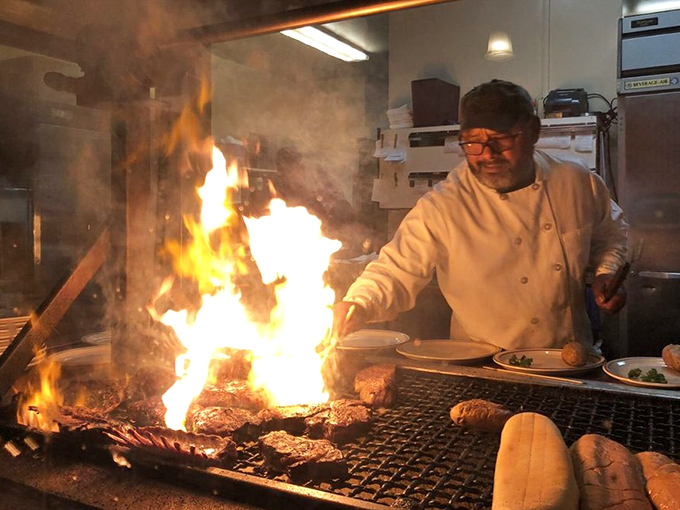 Fire and smoke dance together as the chef orchestrates the ancient ritual of cooking meat over open flame—a primal spectacle that never gets old.