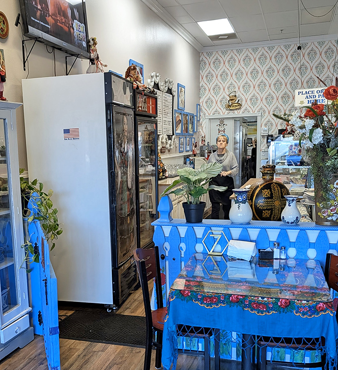 Behind the blue counter, every detail speaks of pride in Polish heritage – from decorative plates to carefully arranged flowers.