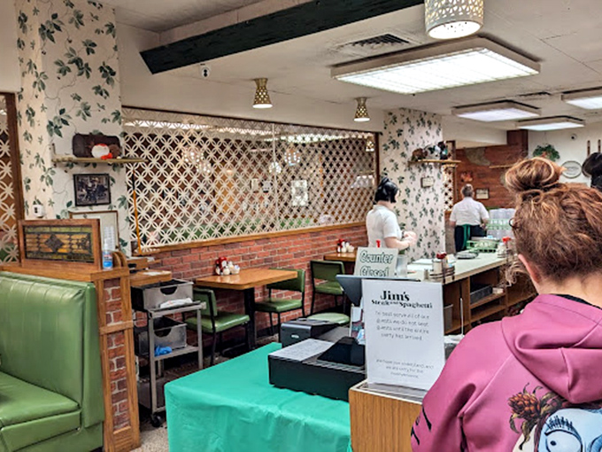 Vintage wallpaper and lattice dividers create dining nooks where conversations flow as freely as the coffee refills.