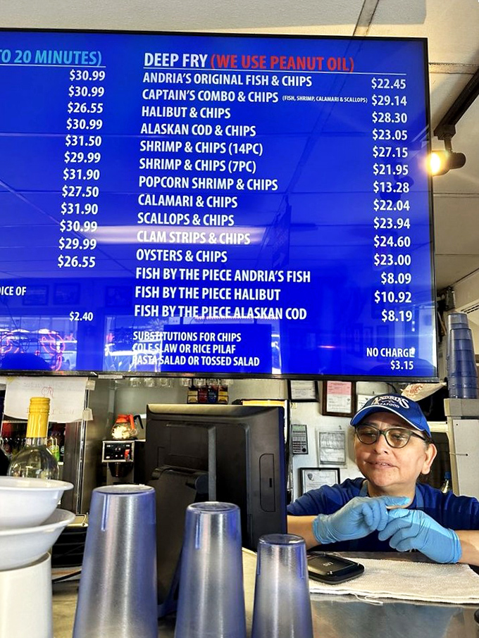 The digital menu board tells a delicious story in blue and white. Those prices might make your wallet wince, but your taste buds will thank you.