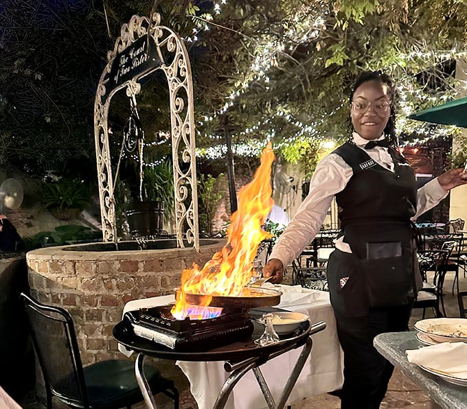 The courtyard dining experience reaches spectacular heights when tableside flames announce the arrival of a classic New Orleans dessert.