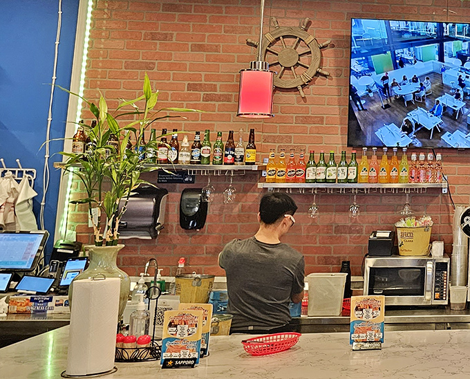 Behind every great seafood feast is a dedicated kitchen crew. The nautical-meets-industrial backdrop sets the stage for culinary magic.