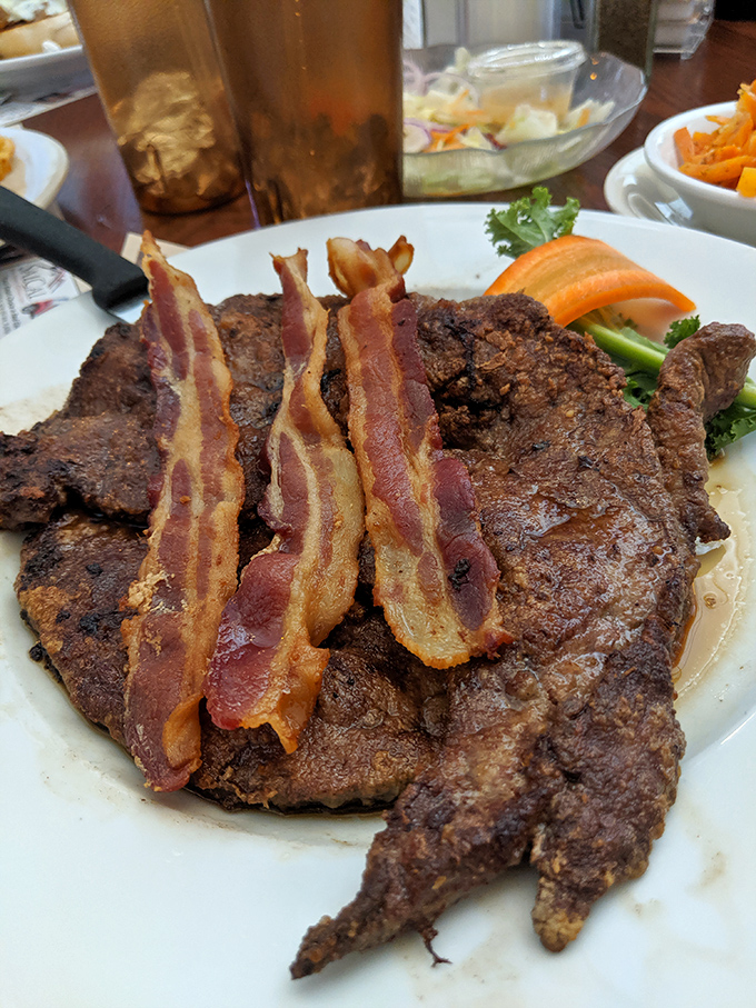 This steak topped with bacon strips isn't just a meal &ndash; it's a declaration that today is not the day you're counting calories.