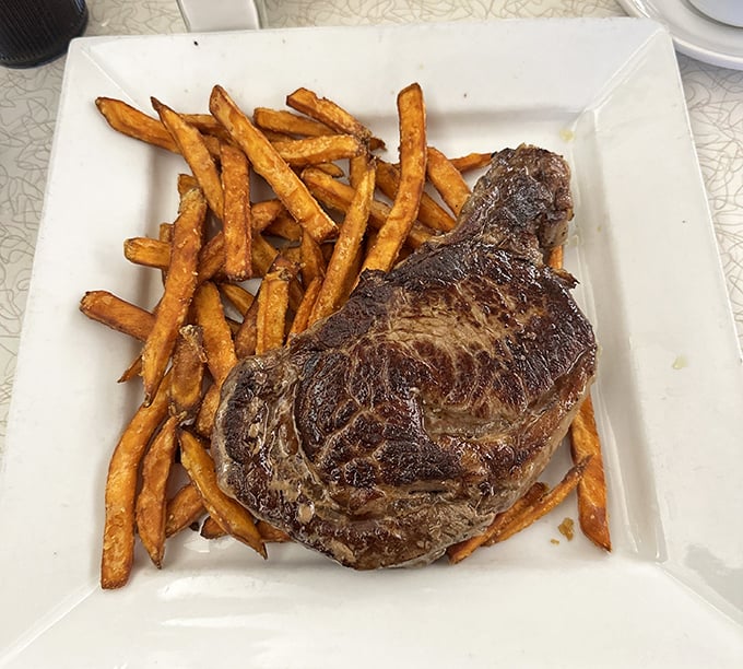 This steak isn't just cooked&mdash;it's been transformed into a carnivore's dream alongside golden fries that crunch like autumn leaves.