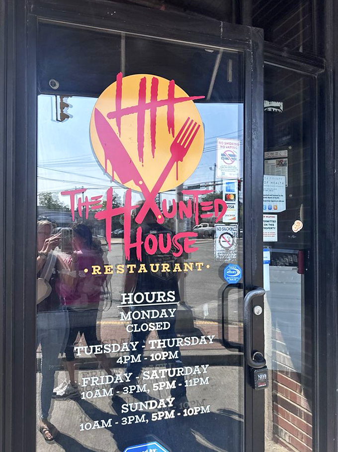 Business hours posted clearly&mdash;because even monsters need to know when dinner is served. The glowing logo promises a dining experience worth planning your day around.