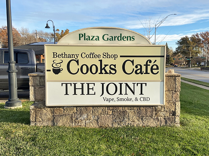 Plaza Gardens proudly announces Cook's Cafe, where morning hunger goes to surrender. The sign might as well say "Biscuit Paradise Ahead."