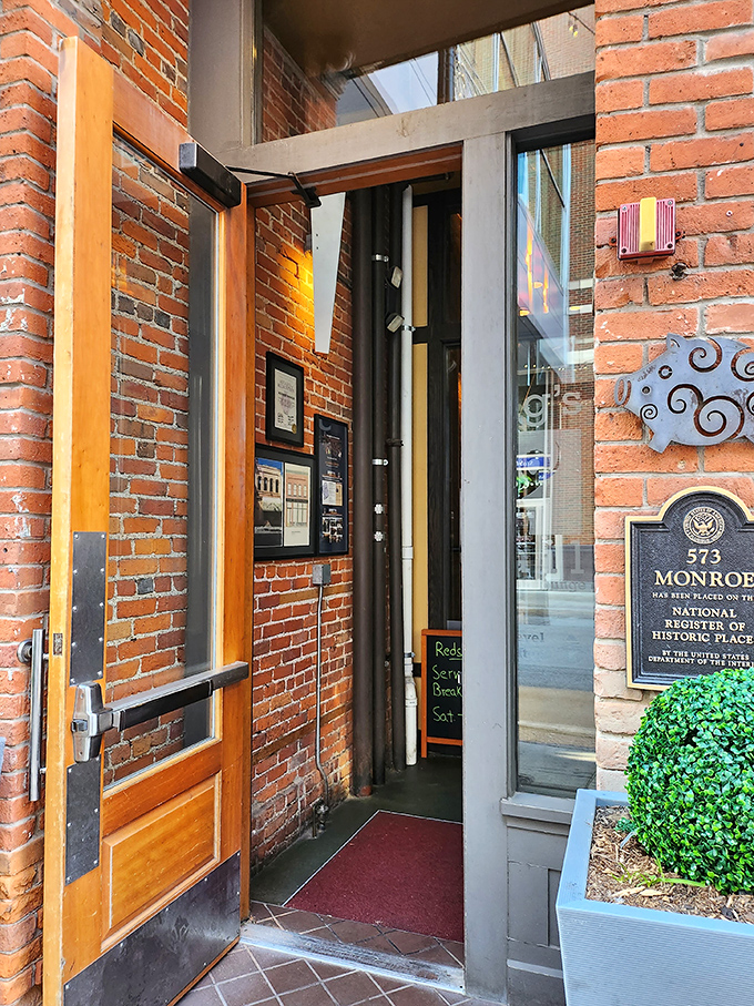 The entrance to meat paradise &ndash; where that historic brick exterior gives way to the promise of smoky delights that await just beyond those wooden doors.