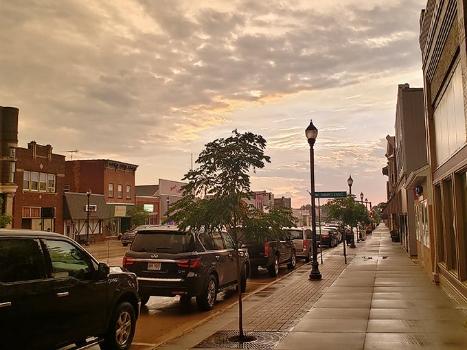 Sunset paints Main Street in golden hues, transforming ordinary lampposts into something from a Hopper painting.