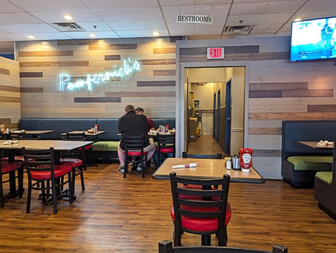 Modern rustic meets comfort at Pumpernick's, where the neon sign glows like a beacon for the sandwich-deprived masses.