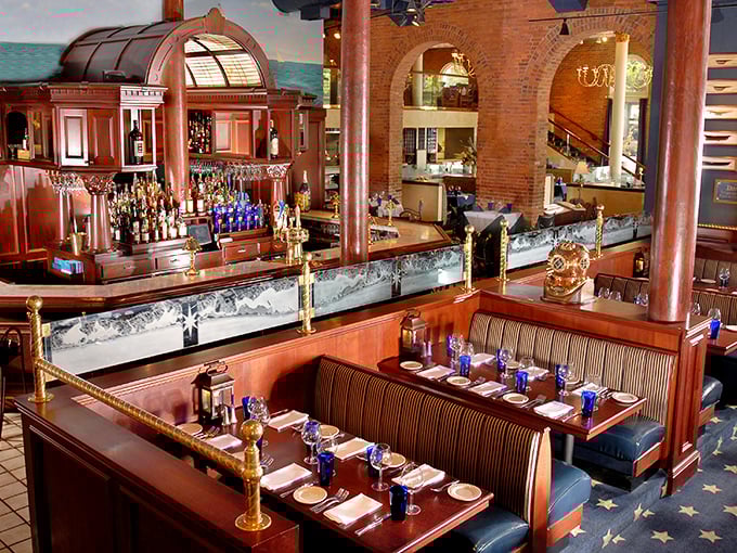 Booths that invite you to settle in for the evening. The rich wood and blue accents say "nautical" without shouting "theme restaurant."