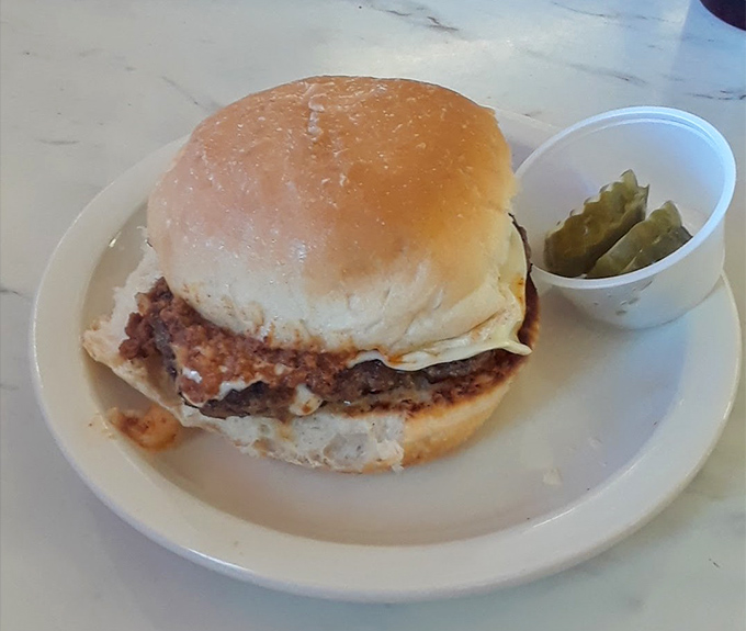 A burger that doesn't need a fancy name or exotic toppings—just honest beef on a proper bun with pickles standing guard.