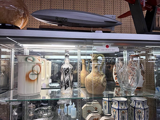 Crystal vases and decorative pieces gleam behind protective glass, showcasing the era's finest craftsmanship.